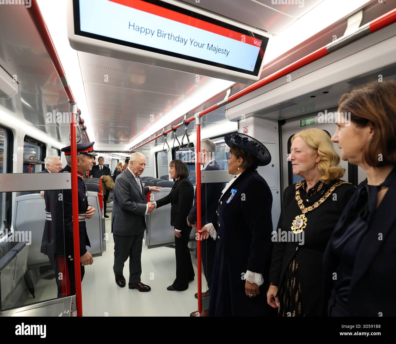 Britain's King Charles III travels on a Stadler Class 398 Tram during a visit to the South Wales ...