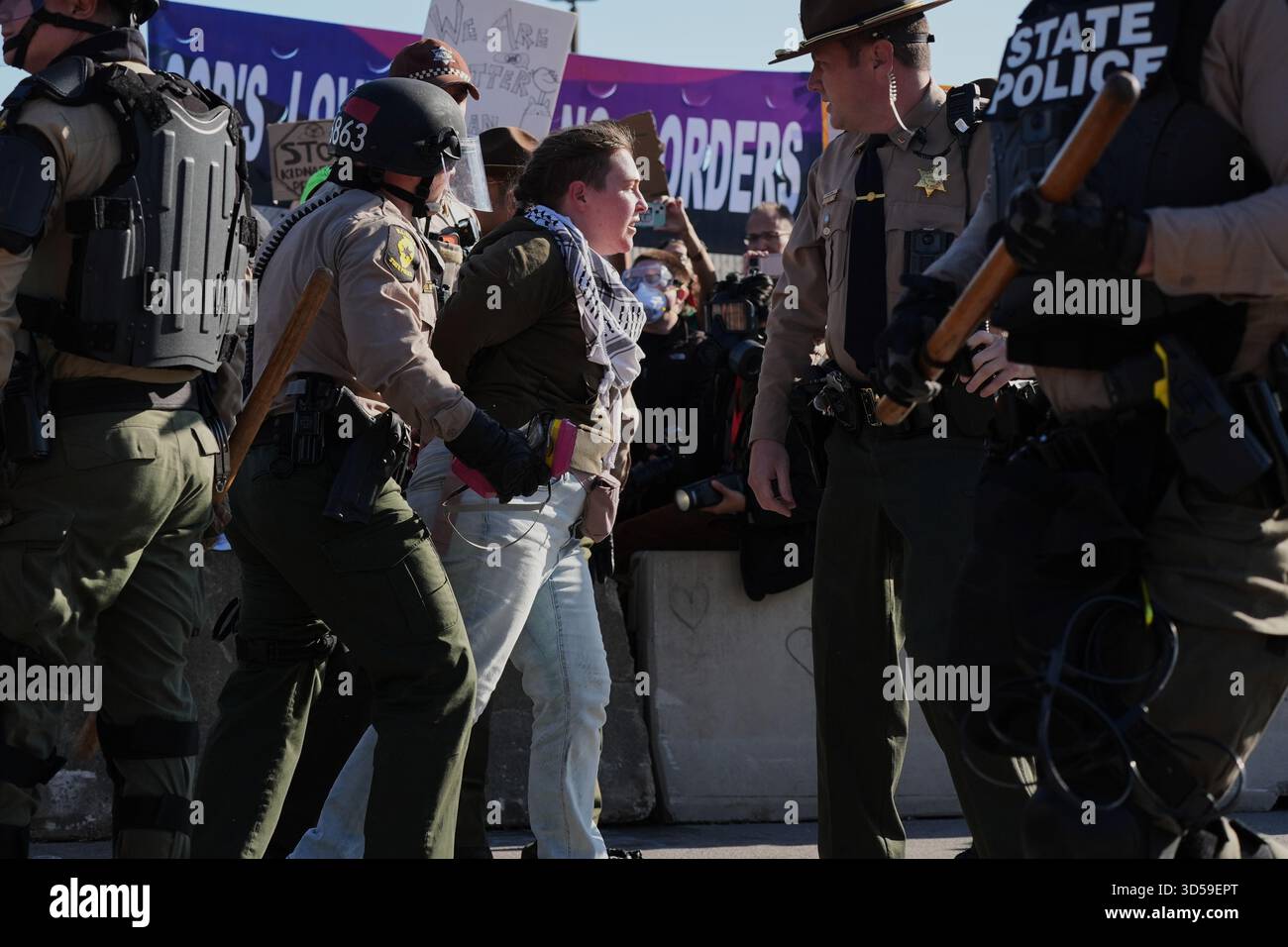 Illinois State police detain a protester outside an ICE processing ...