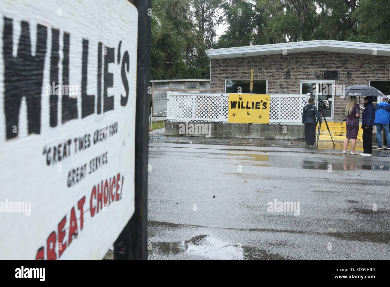 FILE - People stand outside of Willie's Bar and Grill in St Helena ...