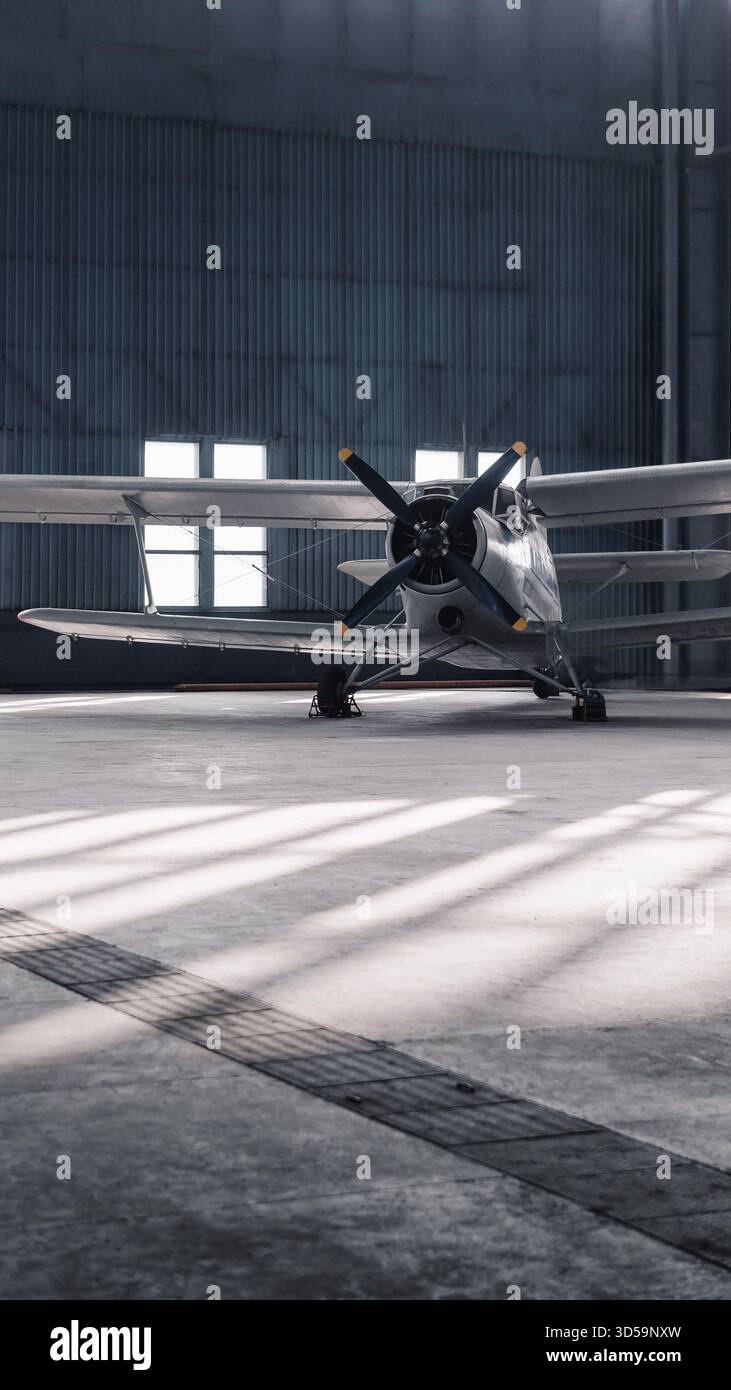 Front view of an old propeller aircraft in a hangar. 9x16 vertical ...
