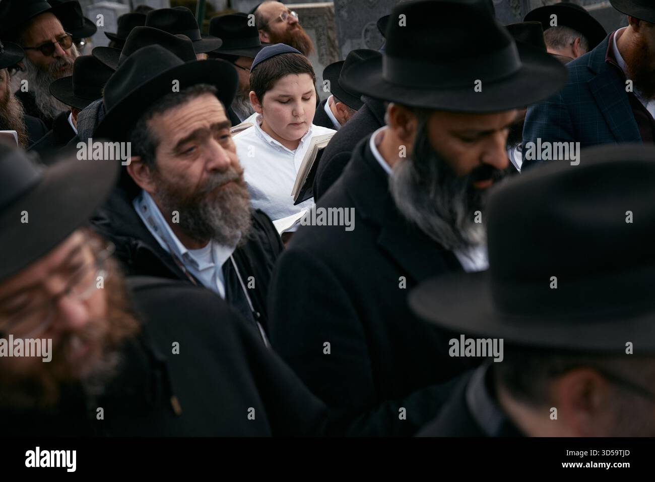 A youth and Chabad-Lubavitch rabbis gather in prayer at the resting ...