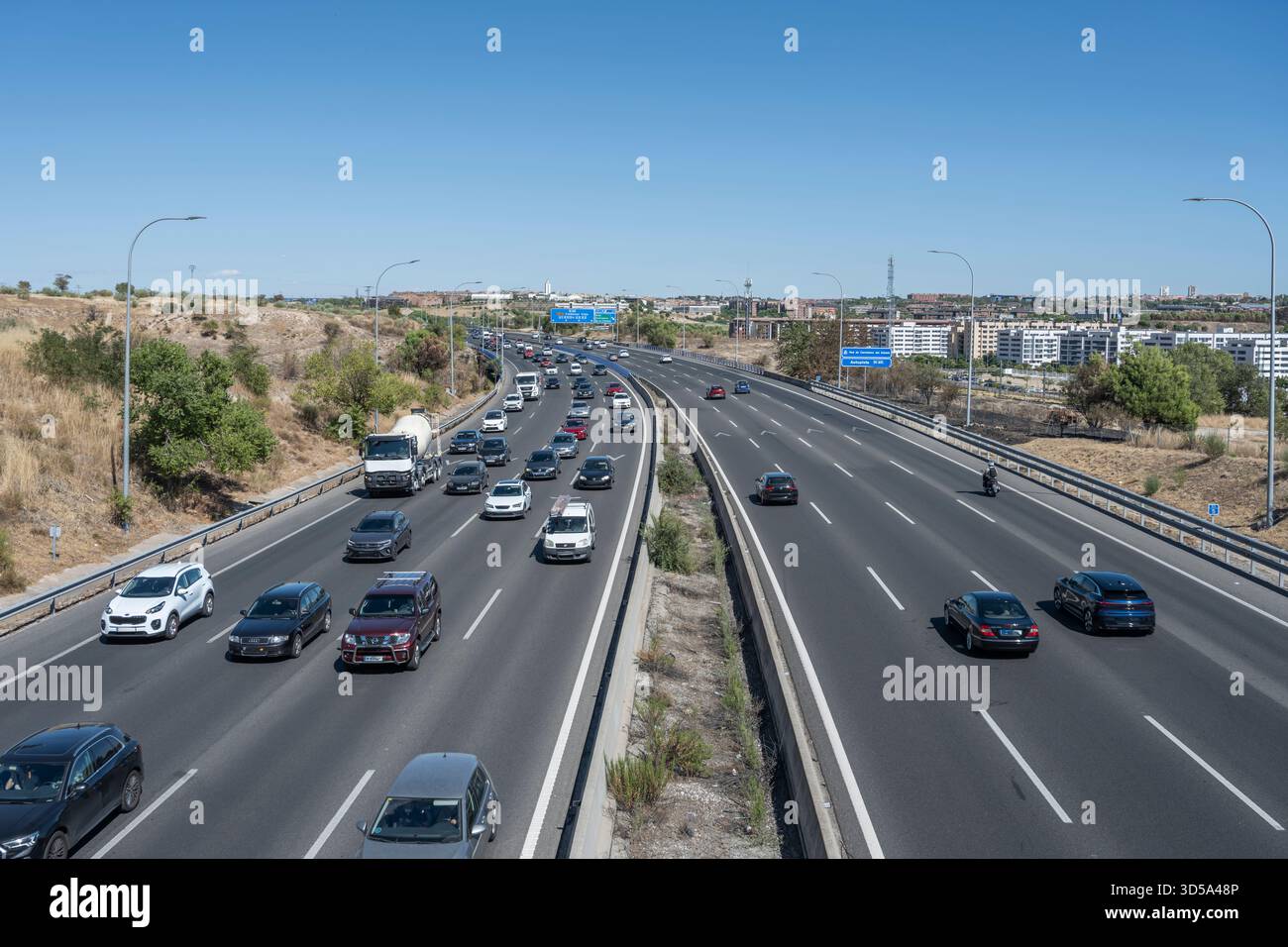 Multi-lane highway clogged with heavy traffic, with cars, trucks, and ...