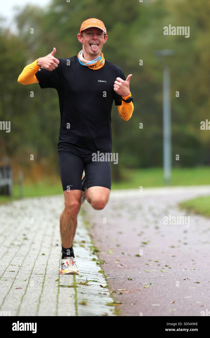 Energetic Runner Giving Thumbs Up on a Park Path Stock Photo - Alamy