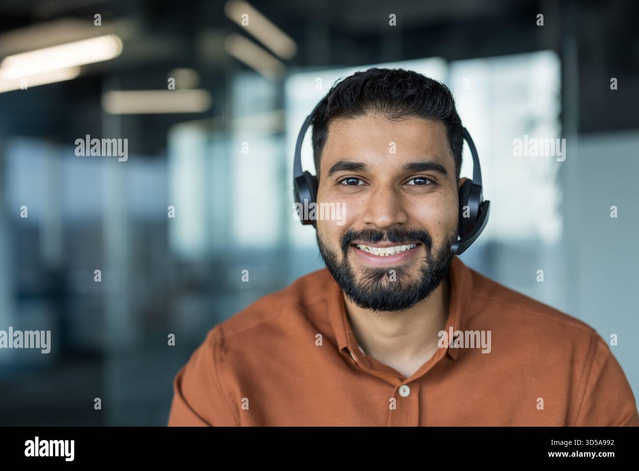 Young indian customer service agent with headset smiling confidently in ...