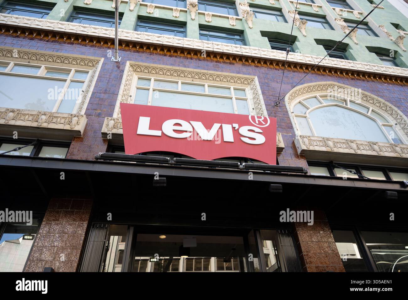 Red Levi's logo sign on ornate building facade at retail storefront ...