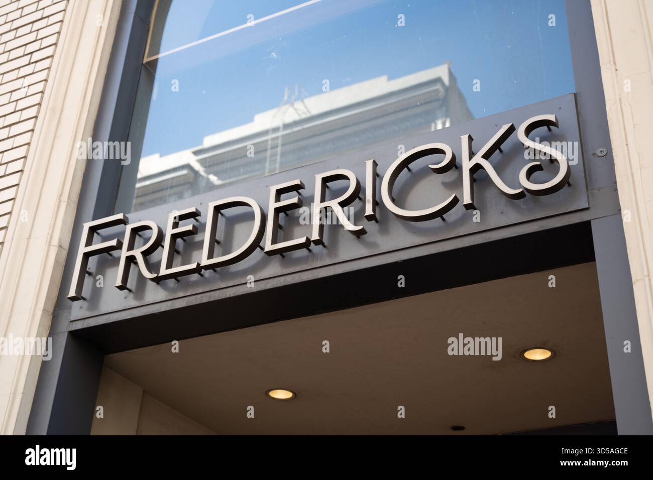 Storefront sign reading Fredericks beneath glass transom on building ...