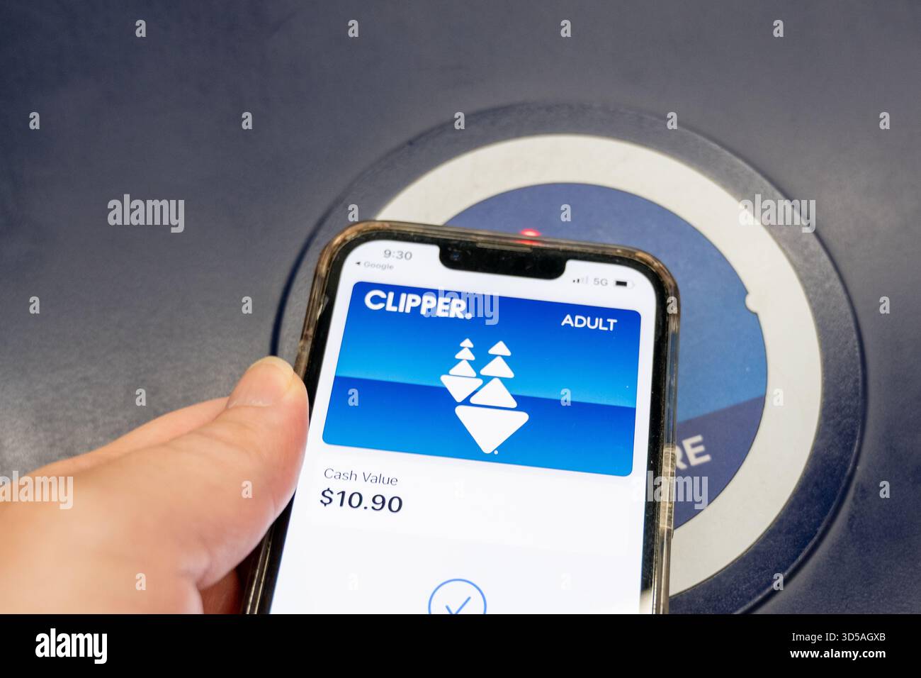 Close-up of smartphone displaying digital Clipper transit card held ...