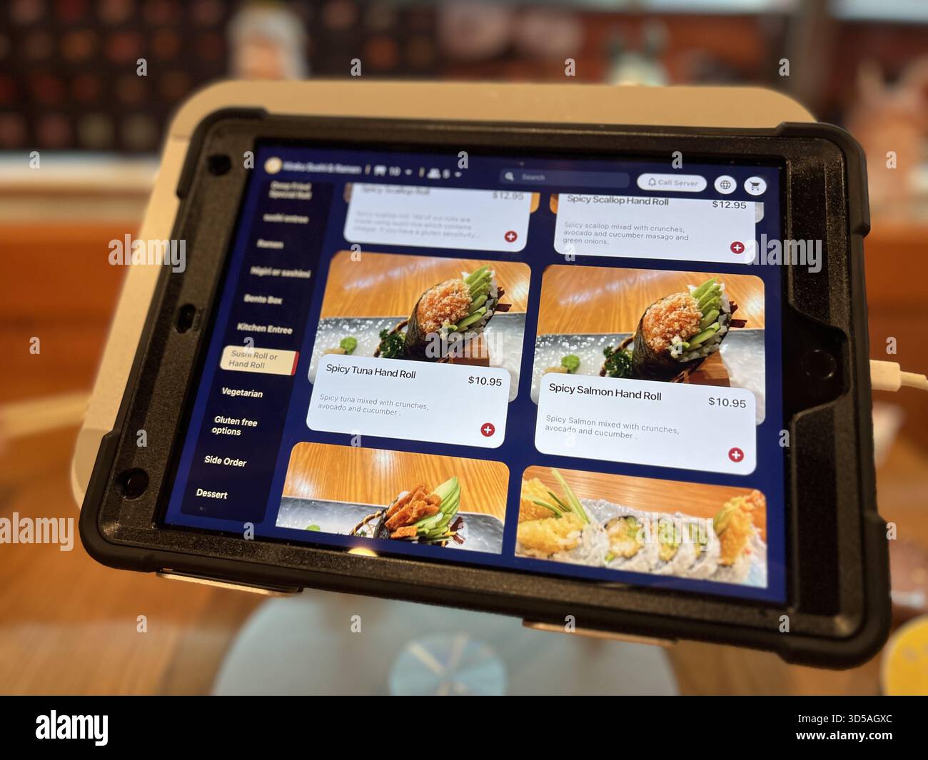 Close-up view of a tablet-based digital ordering system displaying ...