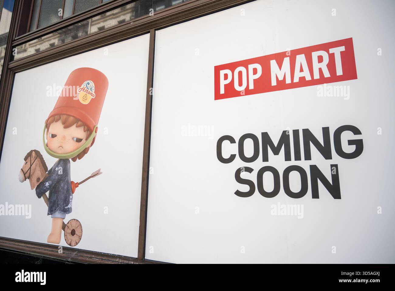 Pop Mart storefront covered with large "Coming Soon" sign and cartoon ...