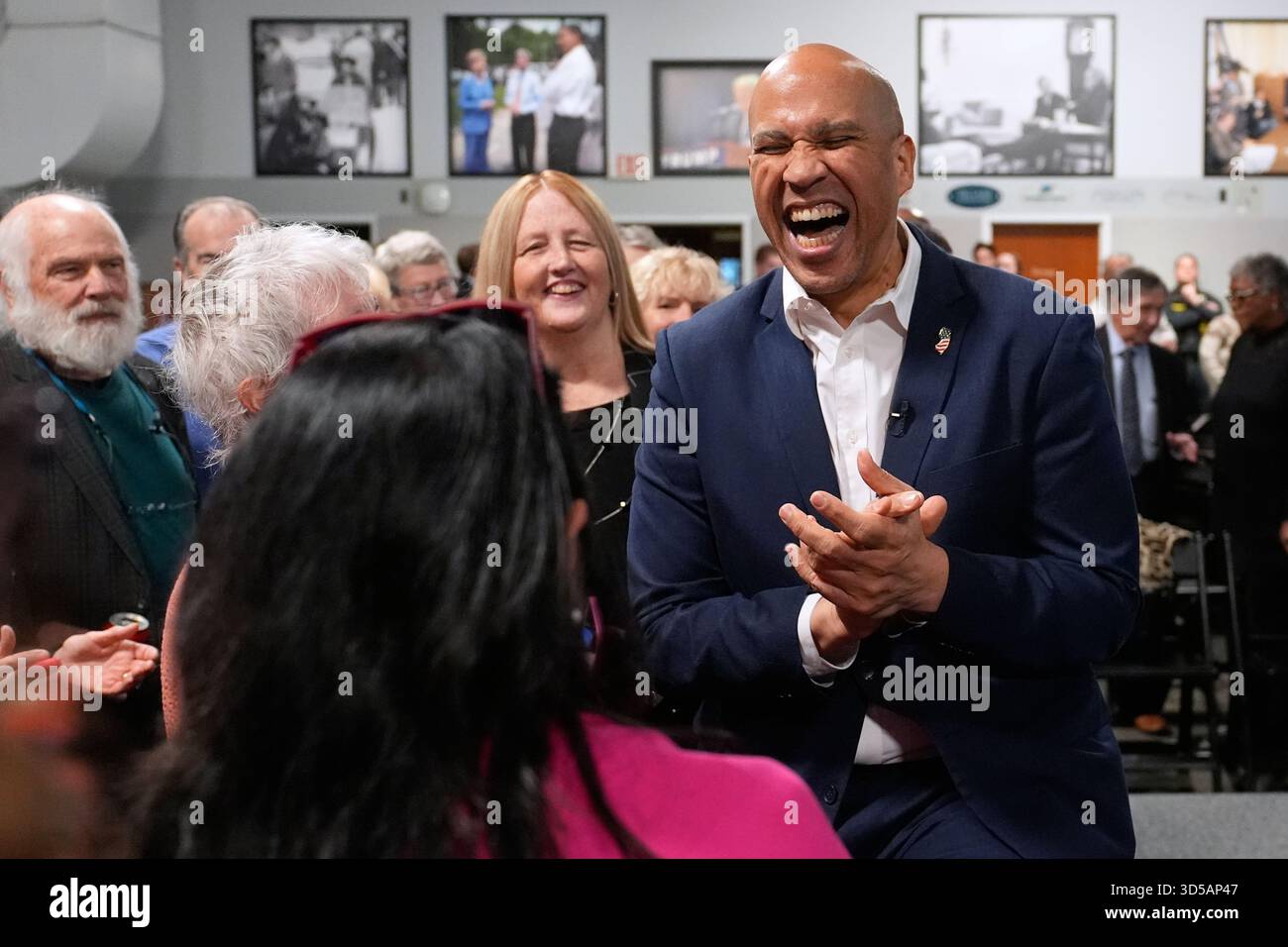 Sen. Cory Booker, D-N.J., laughs with guests during a gathering Friday ...