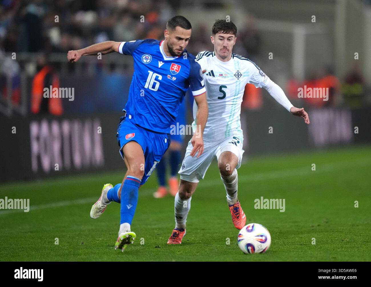 Slovakia's David Hancko (left) and Northern Ireland's Trai Hume battle ...