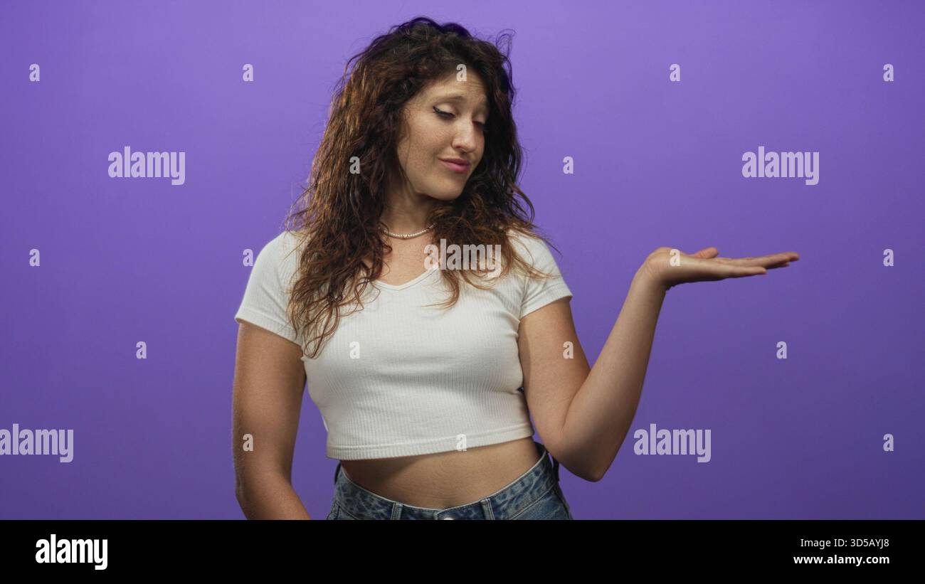 Woman holding palm up with open hand gesture, visible midriff and ...
