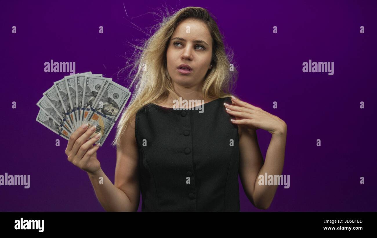 Woman fanning us dollar bills hi-res stock photography and images - Alamy