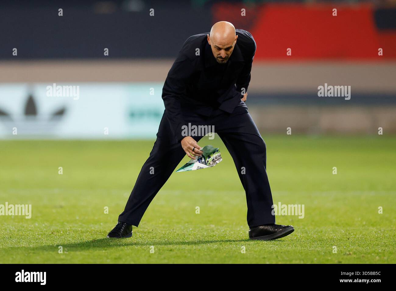 Coach Antonio Di Salvo (Germany) removes a paper airplane from the ...