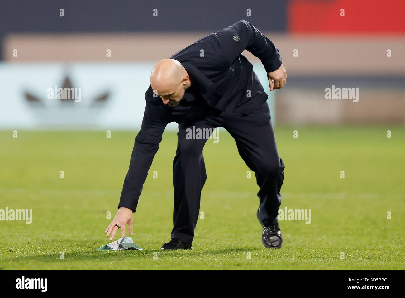 Coach Antonio Di Salvo (Germany) removes a paper airplane from the ...