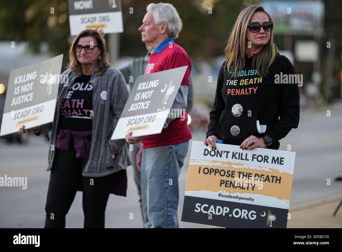 Protestors hold signs outside of the Broad River Correctional Institute ...