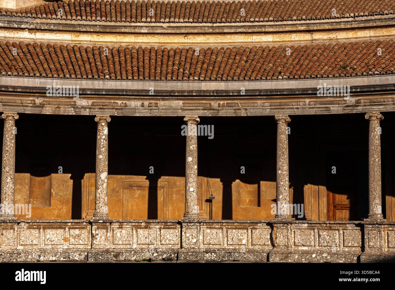 The curved tiled roof and elegant colonnade of Charles V Palace shine ...