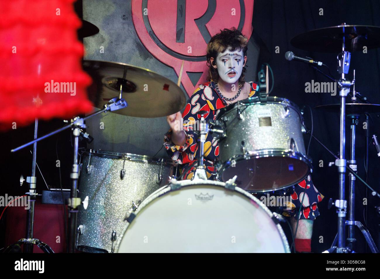 Olly Chrich, drummer of queer punk band The Oozes, performing live ...