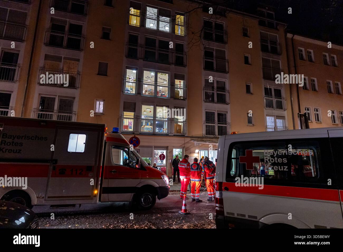 15 November 2025, Bavaria, Nuremberg: Paramedics stand in front of a ...