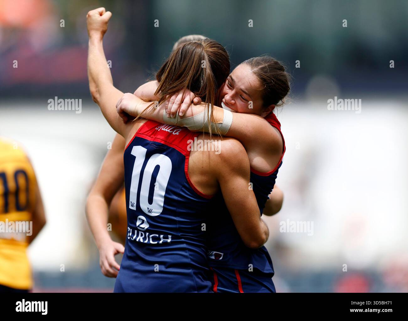 Maggie Mahony of the Demons celebrates a goal with teammates during the ...