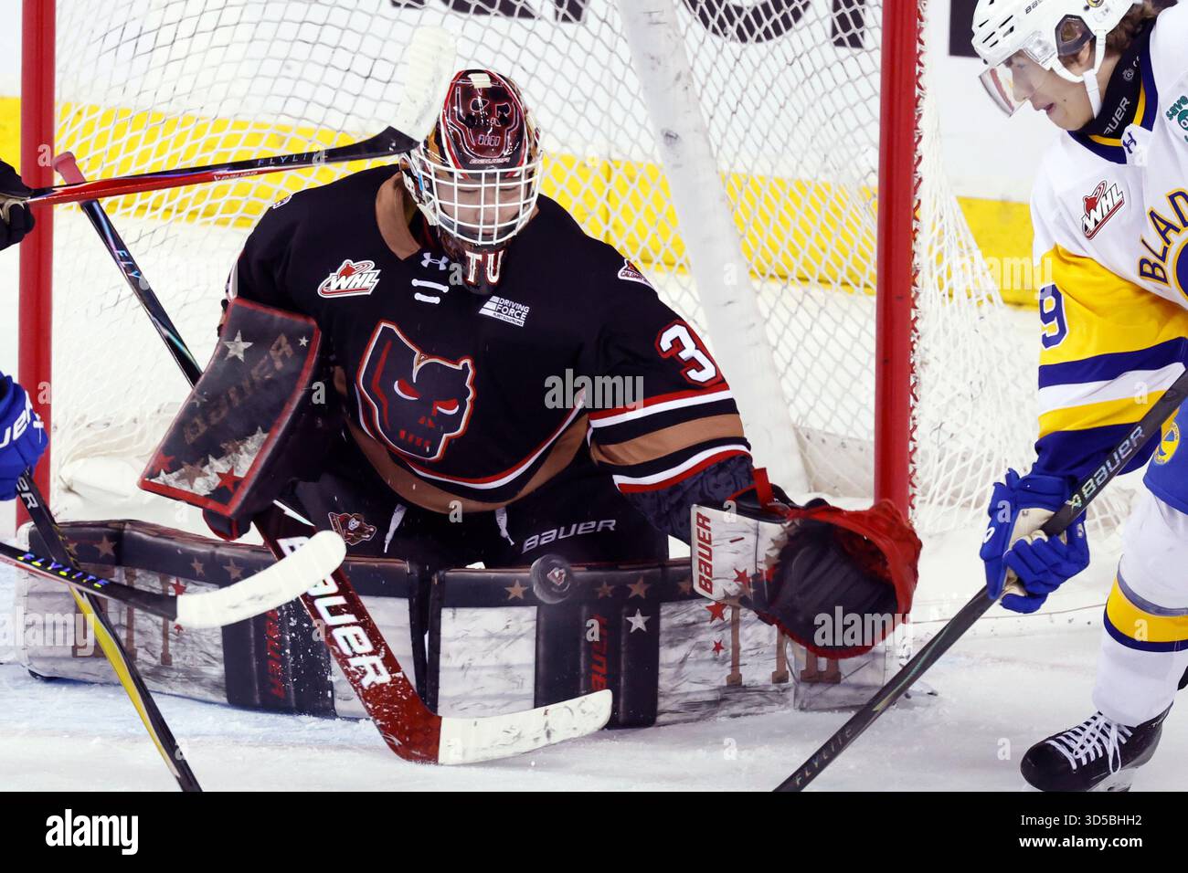 Saskatoon Blades RW Gavin Clark, rt, has a shot stopped by Calgary ...