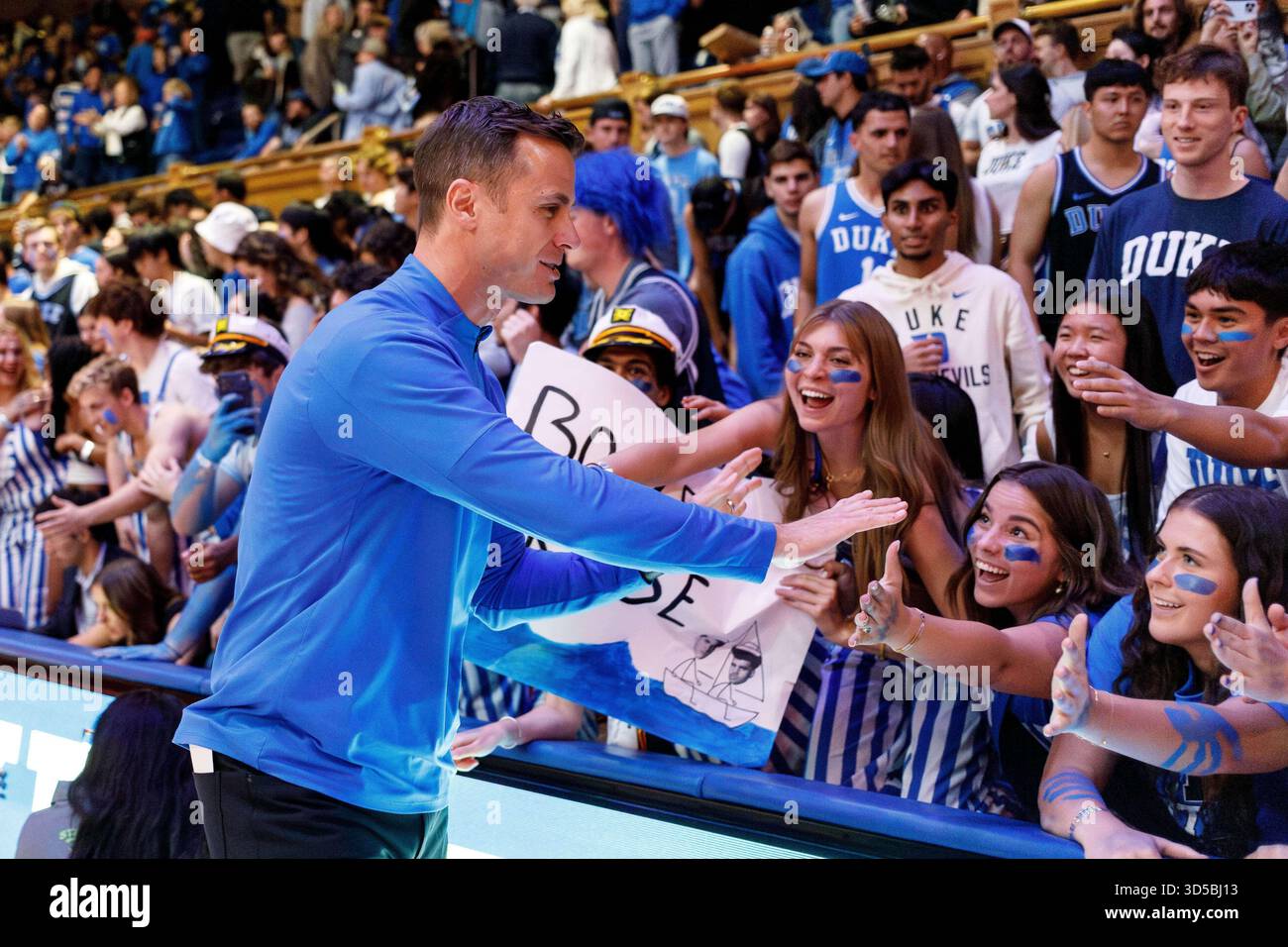 Duke head coach Jon Scheyer high-fives fans after beating Indiana State ...