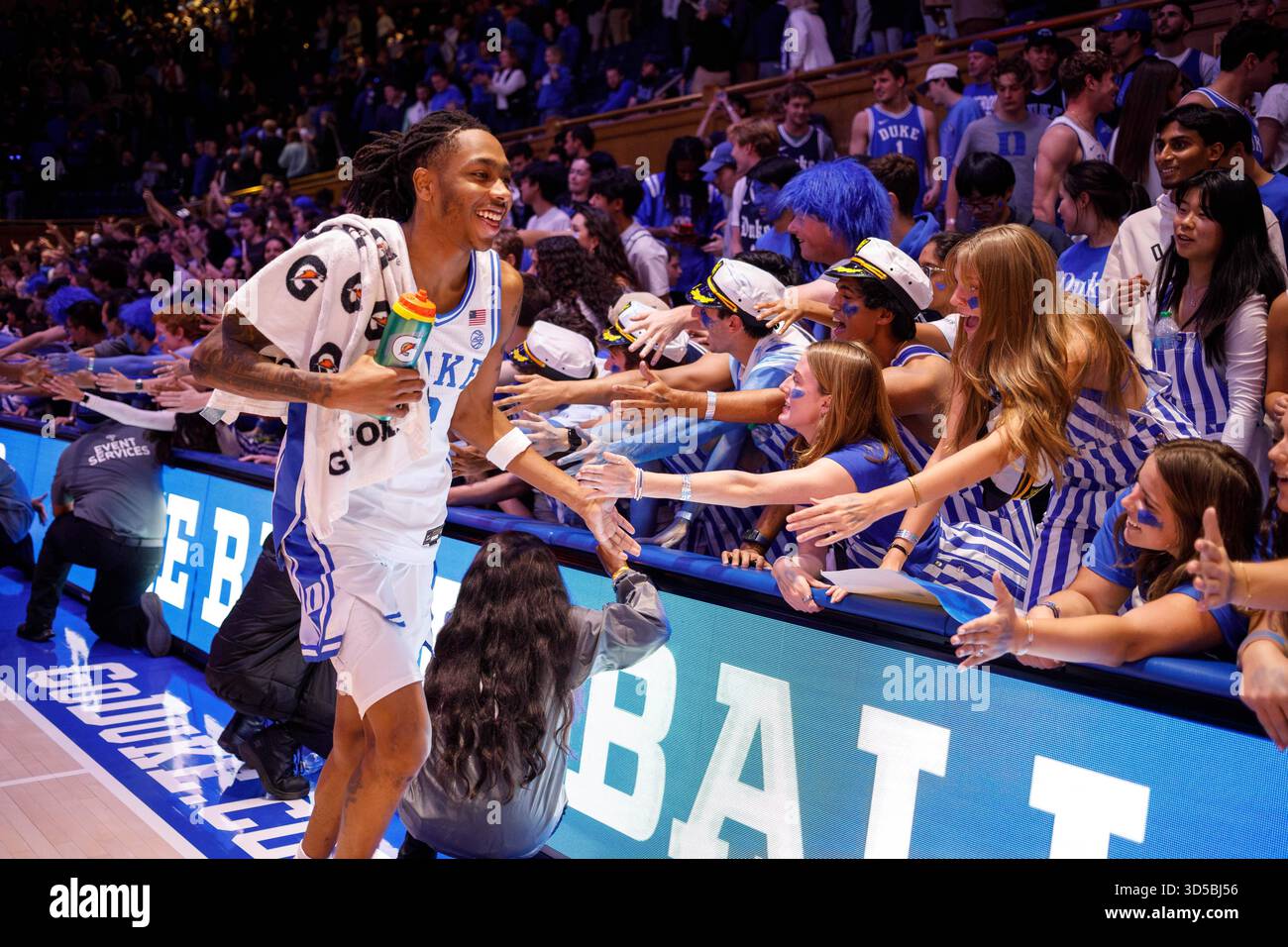 Duke's Isaiah Evans, left, slaps hands with fans after his team ...