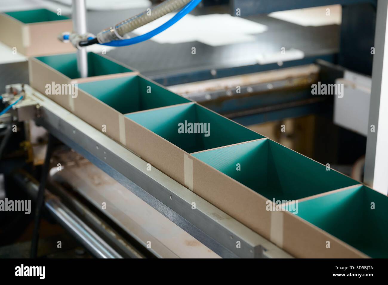 Conveyor belt transporting colorful cardboard boxes in a decorative ...