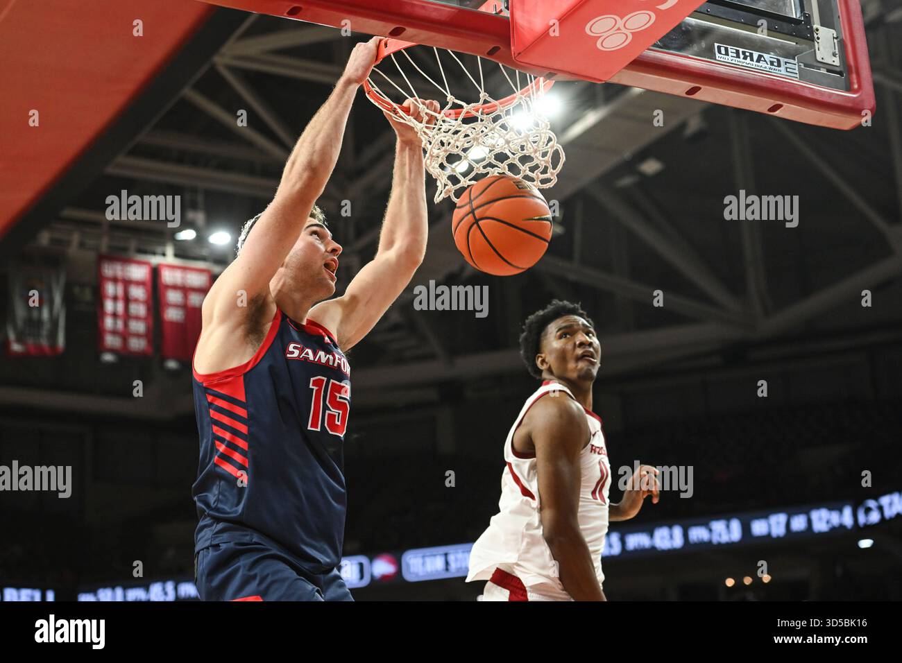Samford forward Dylan Faulkner (15) dunks the ball over Arkansas guard ...