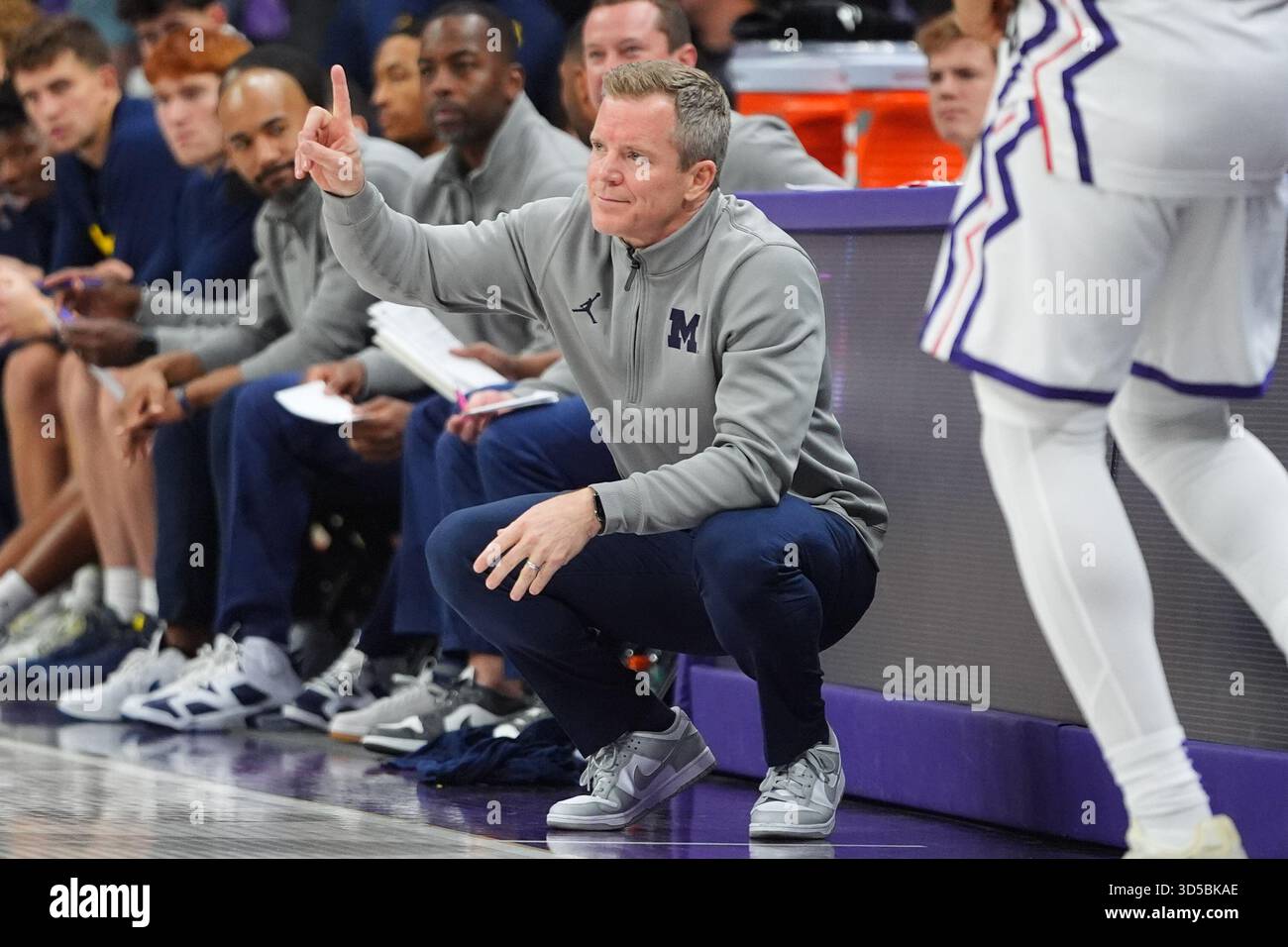 Michigan head coach Dusty May, center, gestures from the sideline ...