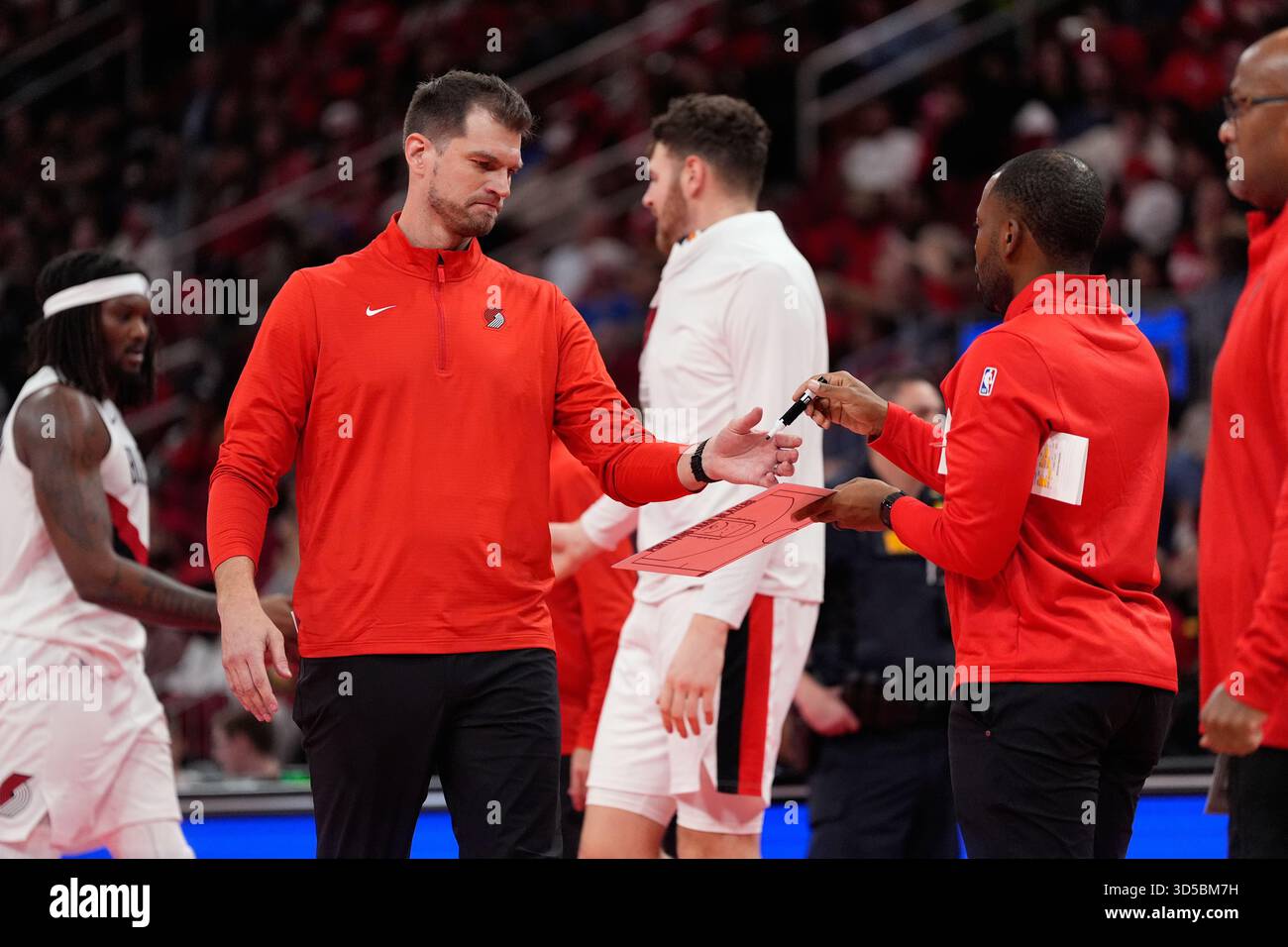 Portland Trail Blazers interim head coach Tiago Splitter, left, takes a ...