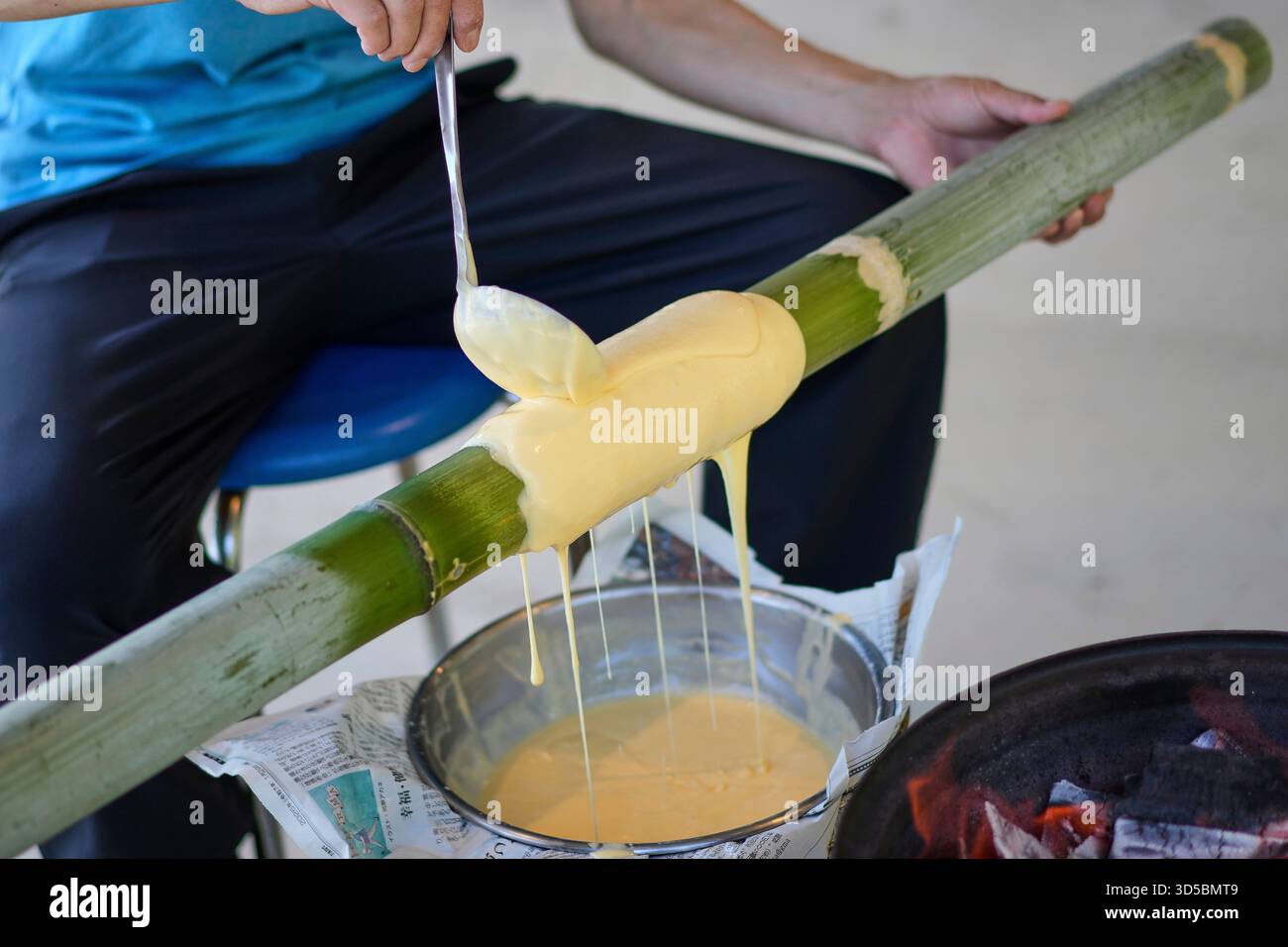 Staff make Baumkuchen, a German layered cake, during a workshop of ...
