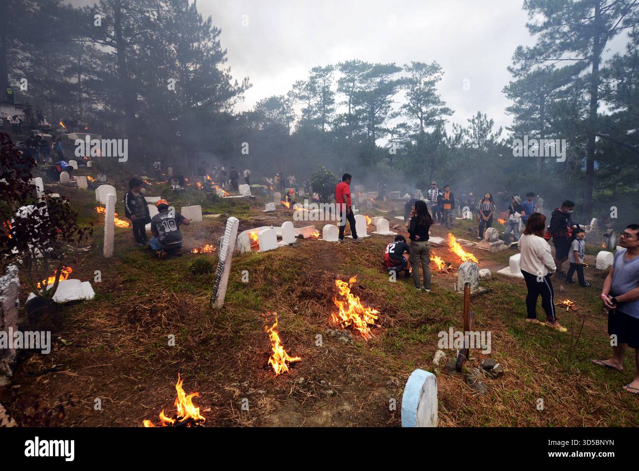 Families light bonfires at the grave of their ancestors at the night of ...