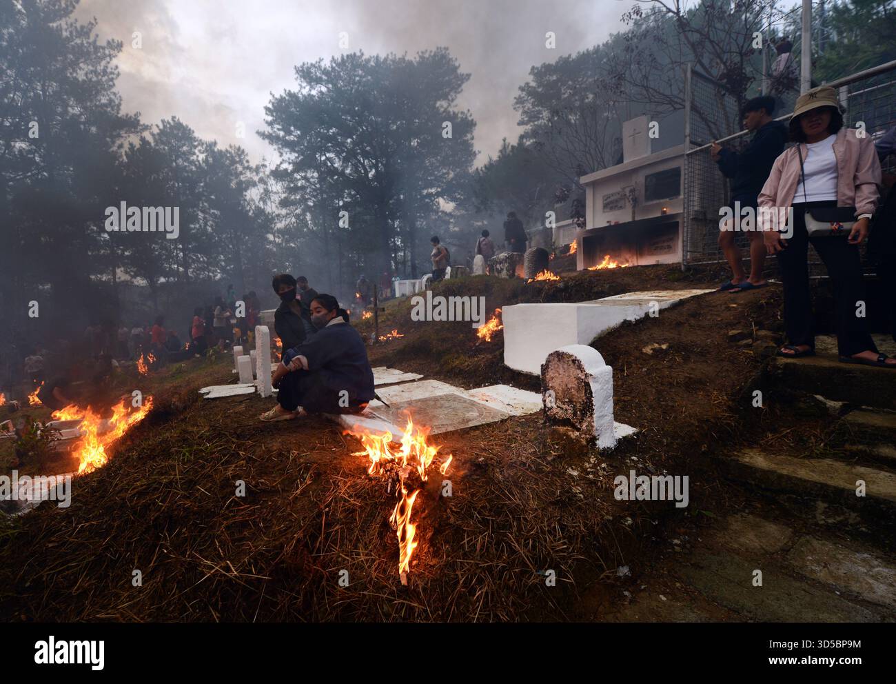 Families light bonfires at the grave of their ancestors at the night of ...