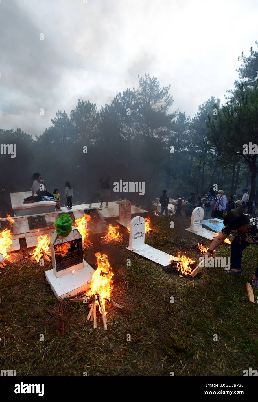 Families light bonfires at the grave of their ancestors at the night of ...