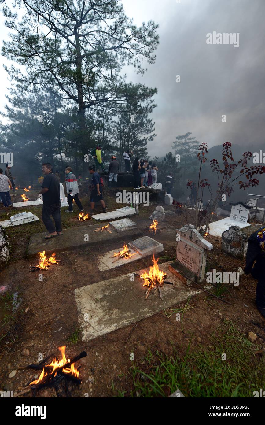 Families light bonfires at the grave of their ancestors at the night of ...