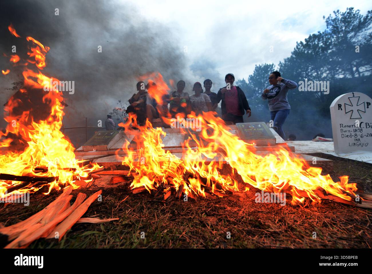 Families light bonfires at the grave of their ancestors at the night of ...