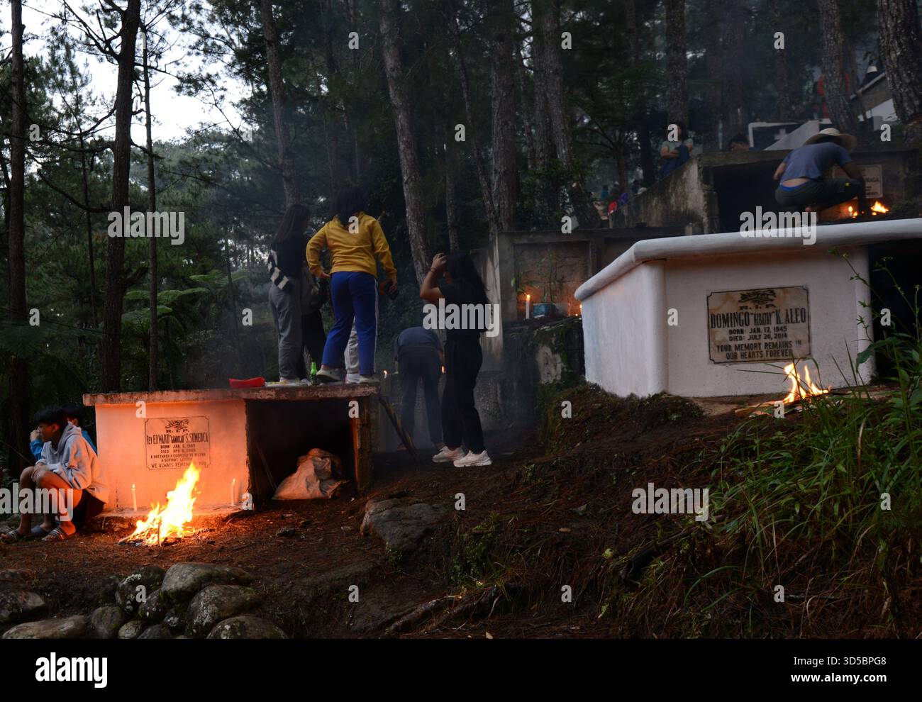 Families light bonfires at the grave of their ancestors at the night of ...