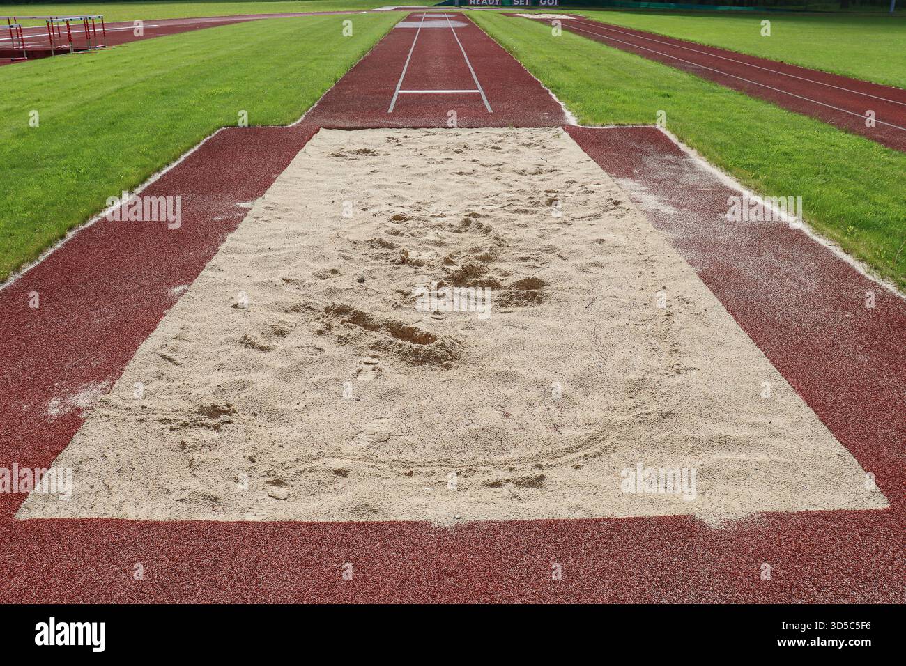 An empty jumping pit with shoe prints. Track and field concept Stock ...