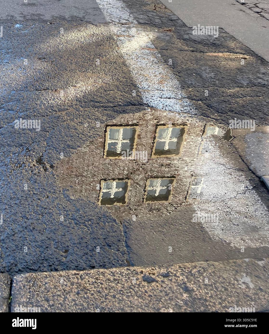 Urban illusion: a tiny brick house reflection in a street puddle ...