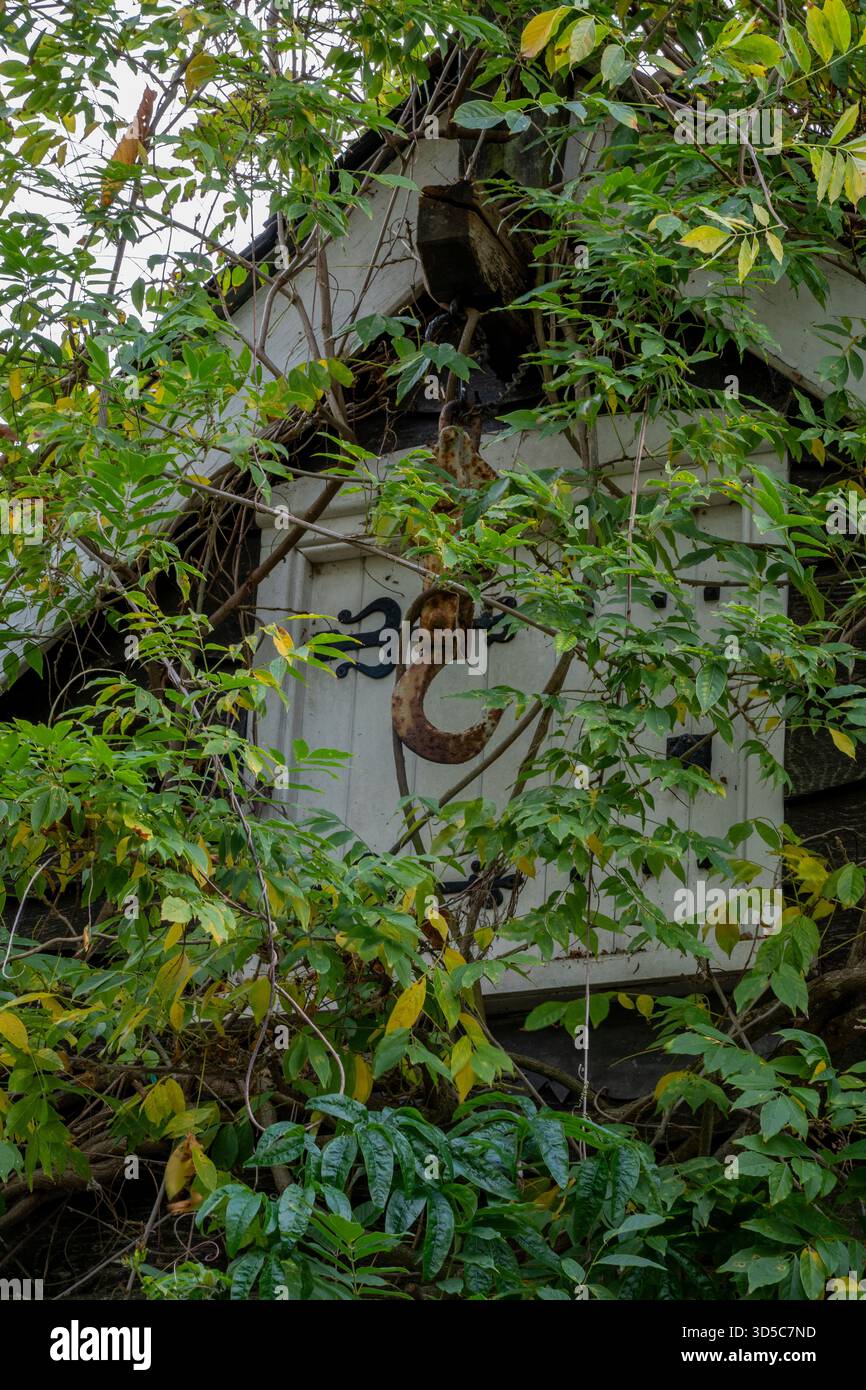Old rusty block and tackle hanging outside of the loft or hayloft of a ...