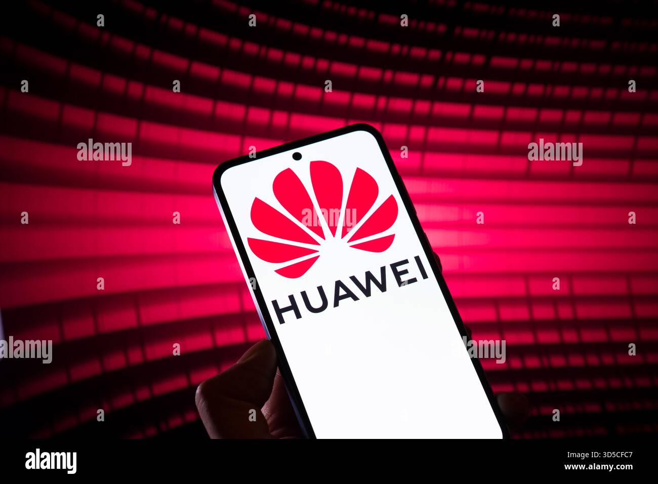 The Huawei Corporation logo is being displayed on a mobile phone with a ...