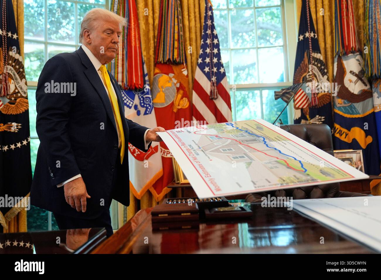 FILE - President Donald Trump holds a chart as he discusses the economy ...