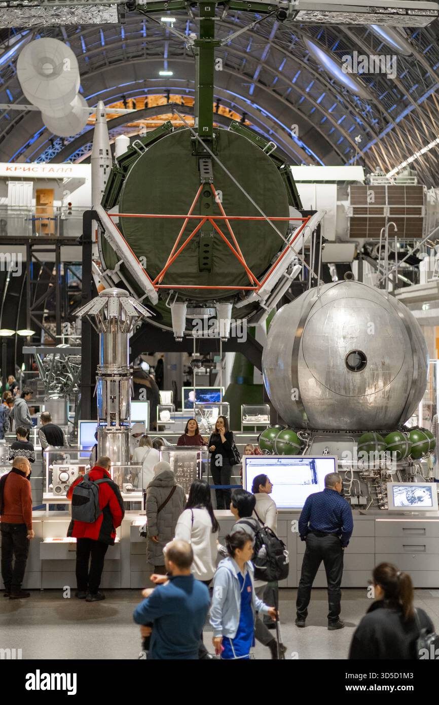 Visitors Explore a Space Exhibit Showcasing a Large Spacecraft and ...