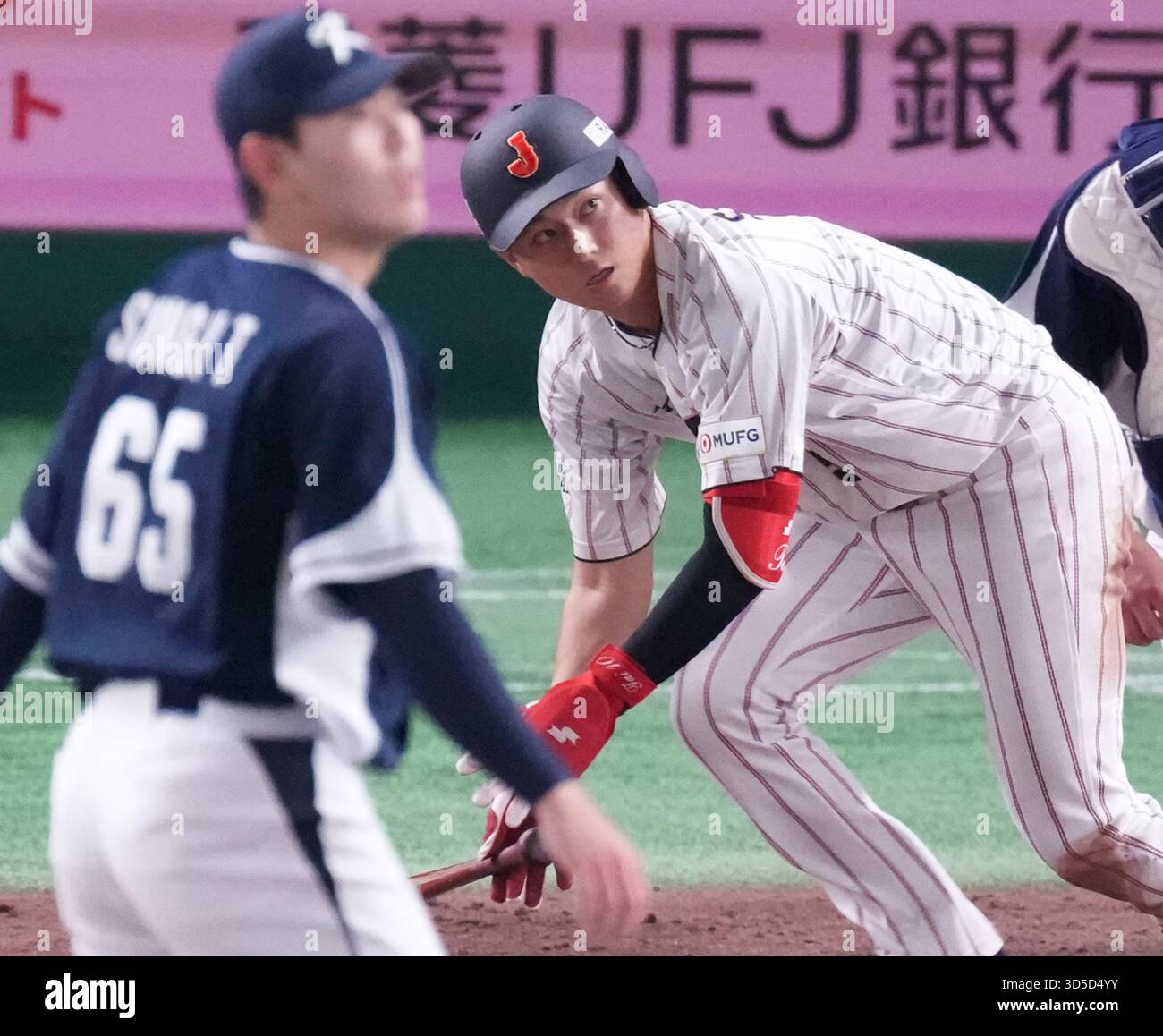 Japan infielder Tai SASAKI hits a two-run RBI single in the fifth ...