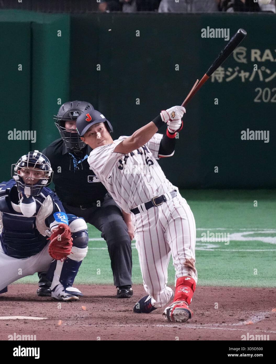 Japan infielder Tai SASAKI hits a two-run RBI single in the fifth ...