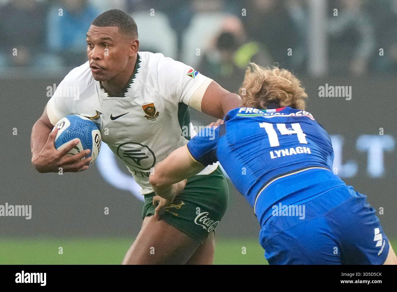 South Africa's Damian Willemse is tackled by Italy's Louis Lynagh ...