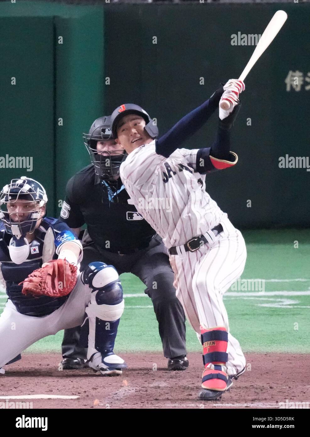 Japan outfielder Misho NISHIKAWA hits a two-run double to tie the game ...