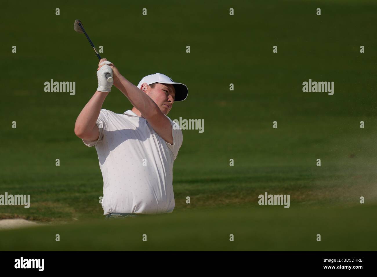 Robert MacIntyre of Scotland hits a shot from a bunker on the 9th hole ...