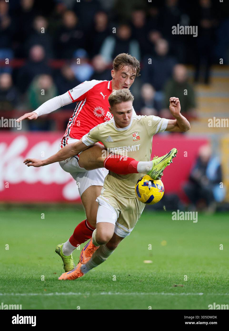 Fleetwood Town's Lewis McCann (left) fouls Swindon Town's Paul Glatzel ...